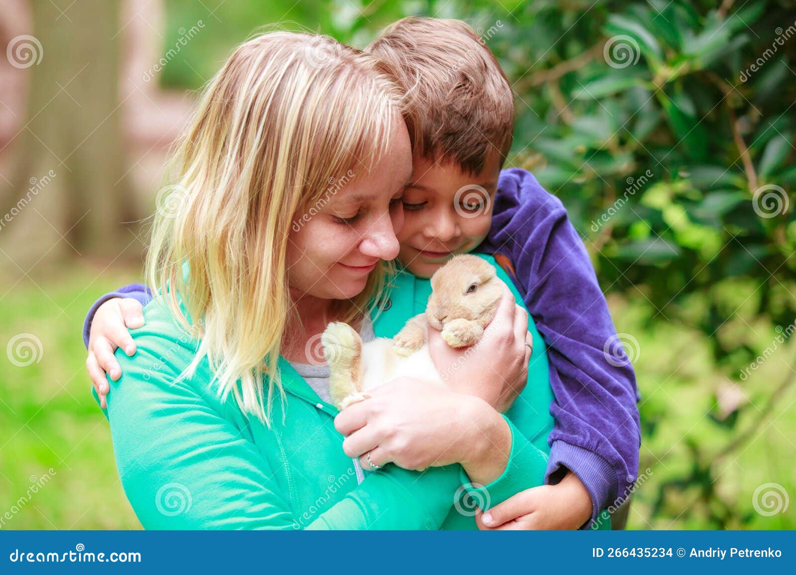 Happy Family with a Rabbit in Their Hands in the Park Stock Photo ...