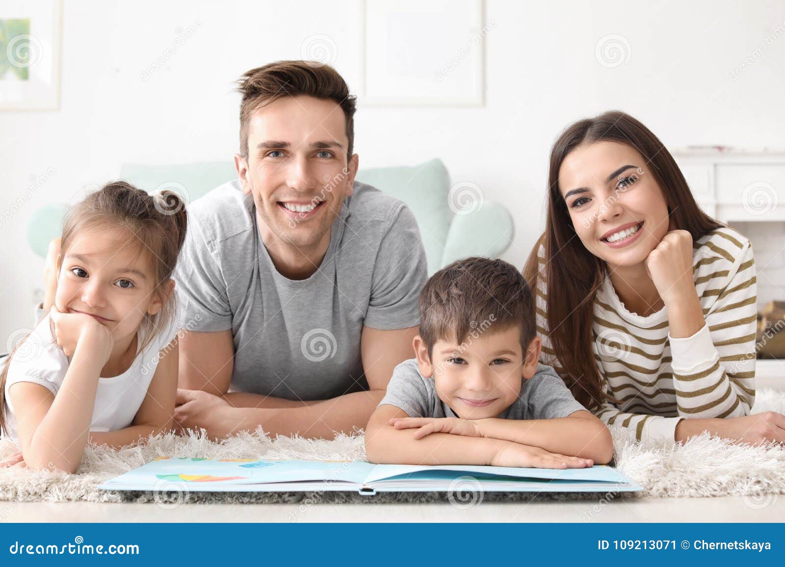 Happy family reading book stock image. Image of daughter - 109213071