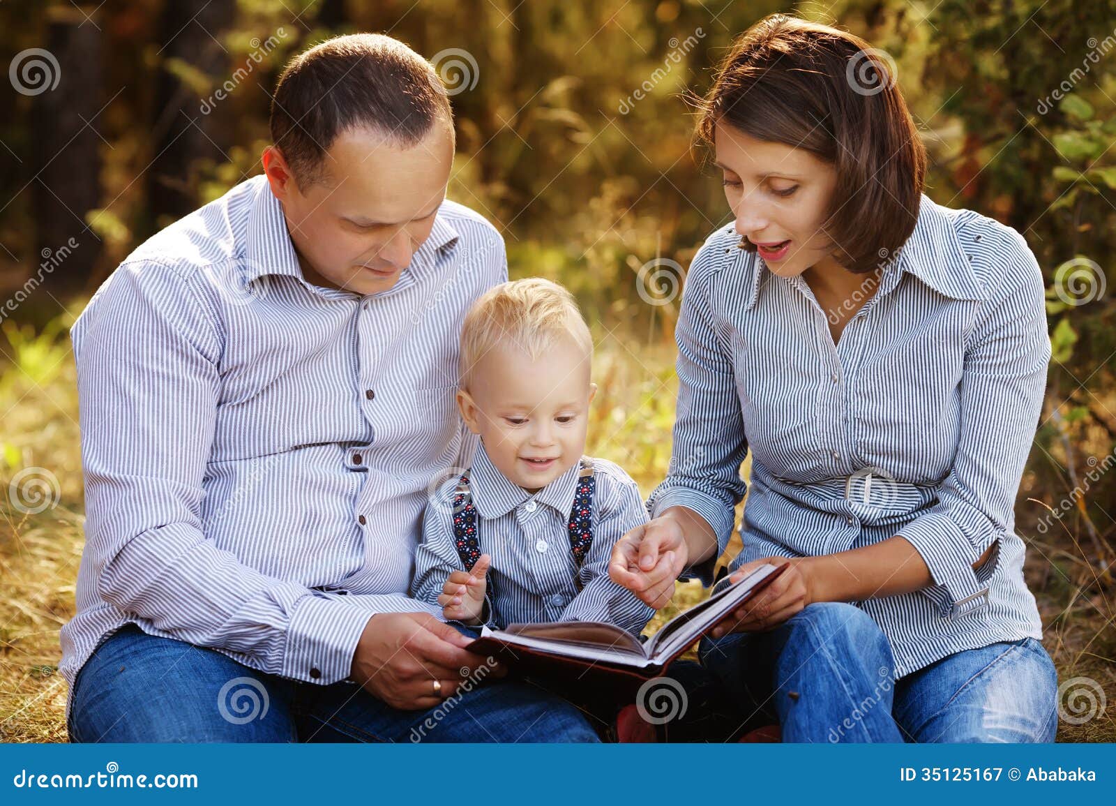 Happy family reading book stock image. Image of father - 35125167