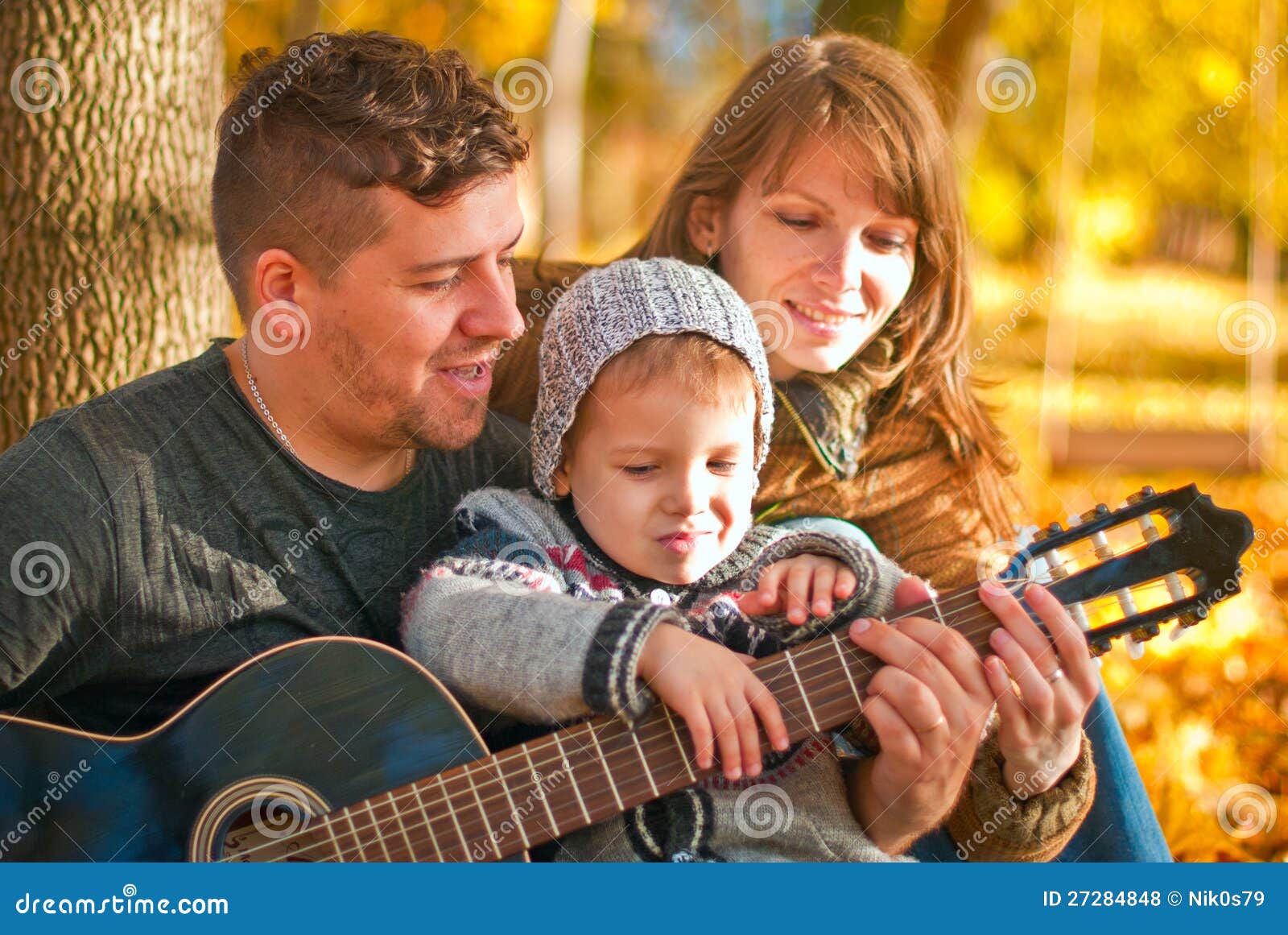 Happy Family Relaxing Outdoors Stock Photo - Image of guitar, colorful ...
