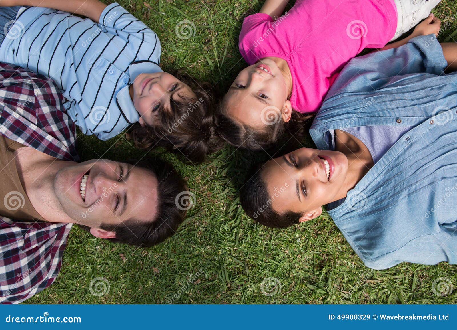 Happy Family Smiling at Camera Stock Image - Image of green, love: 49900329