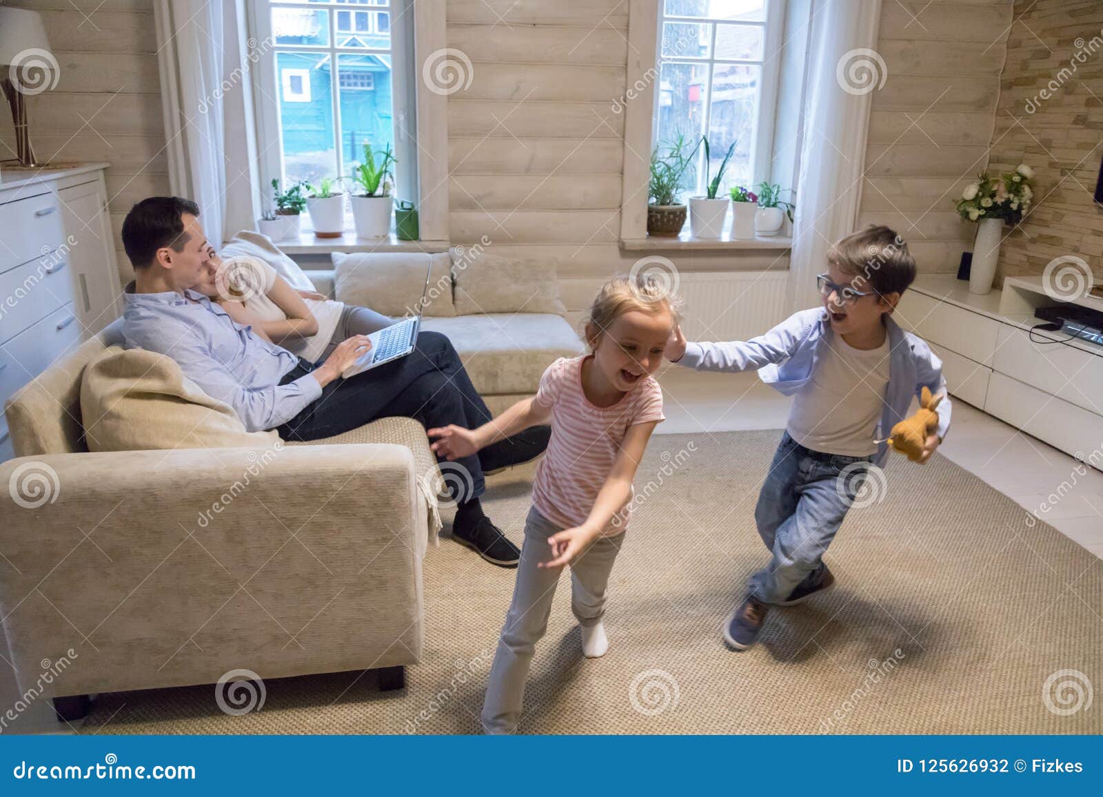 Happy Family Spending Time at Home Having Fun Together Stock Photo ... Happy Family Spending Time at Home Having Fun Together Stock Photo ...