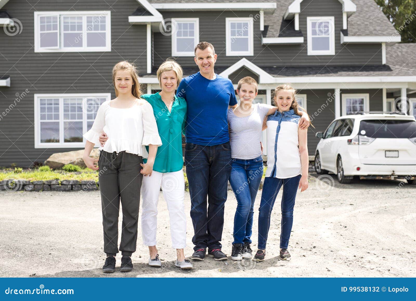 Happy Family Standing in Front of the House Stock Photo - Image of pair ...