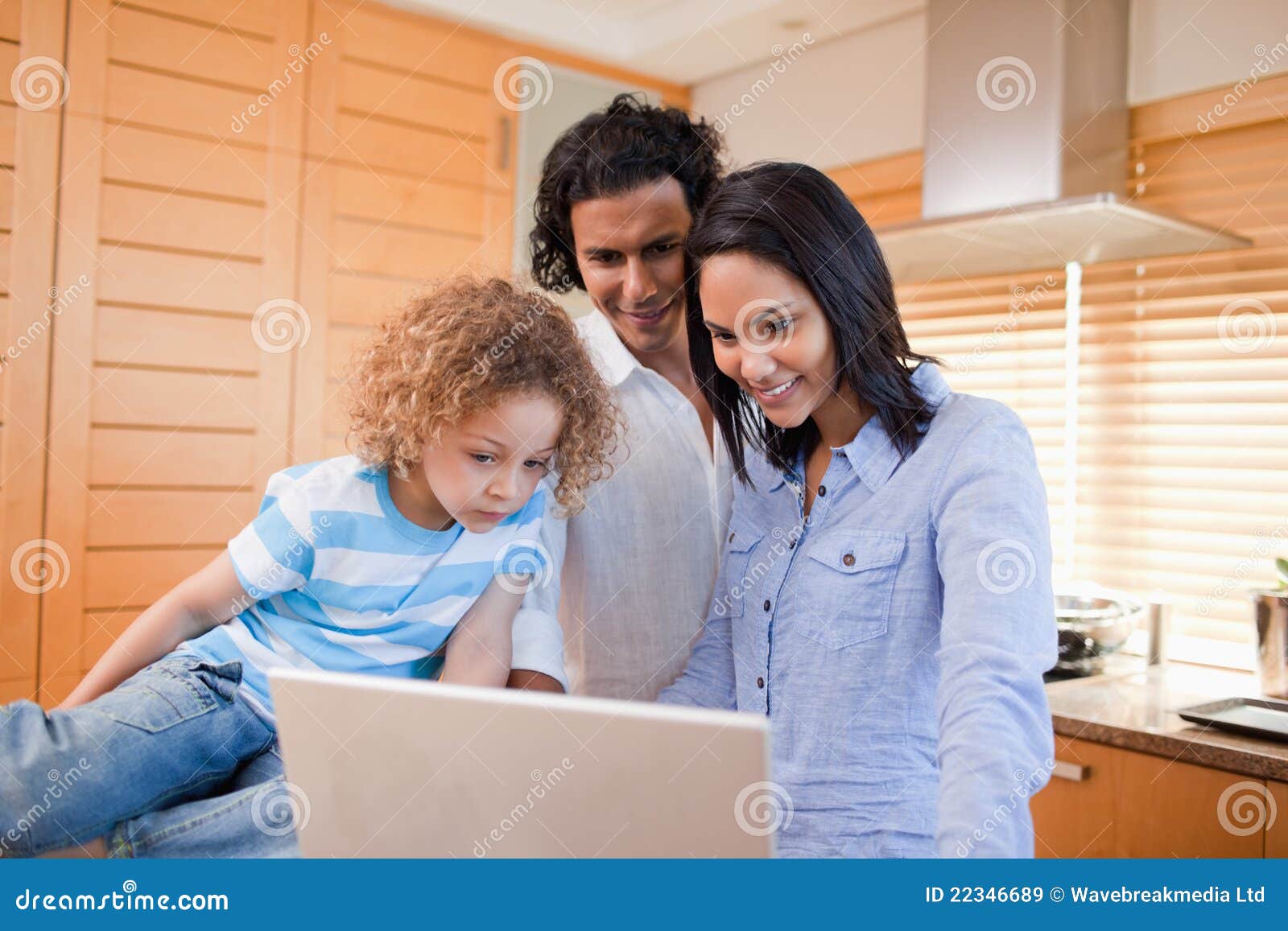 Happy Family Surfing the Internet in the Kitchen Together Stock Image ...