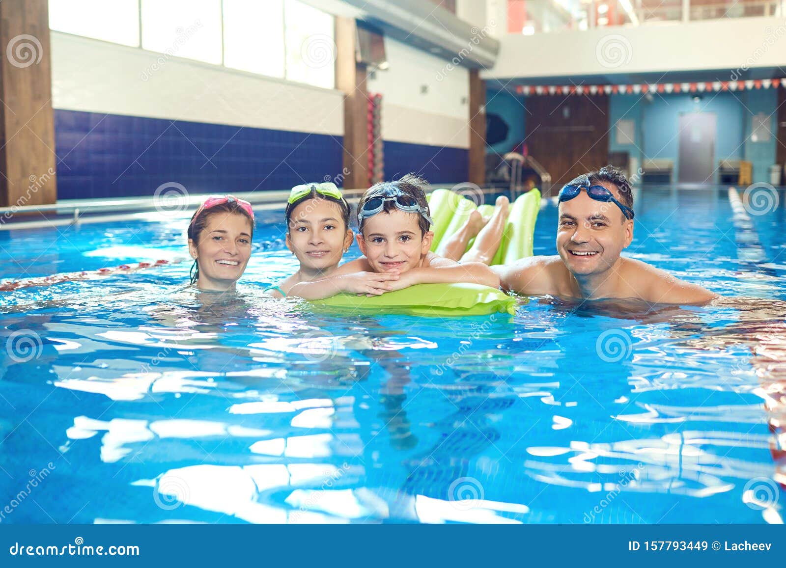 Happy Family Swimming in the Swimming Pool. Stock Image - Image of ...