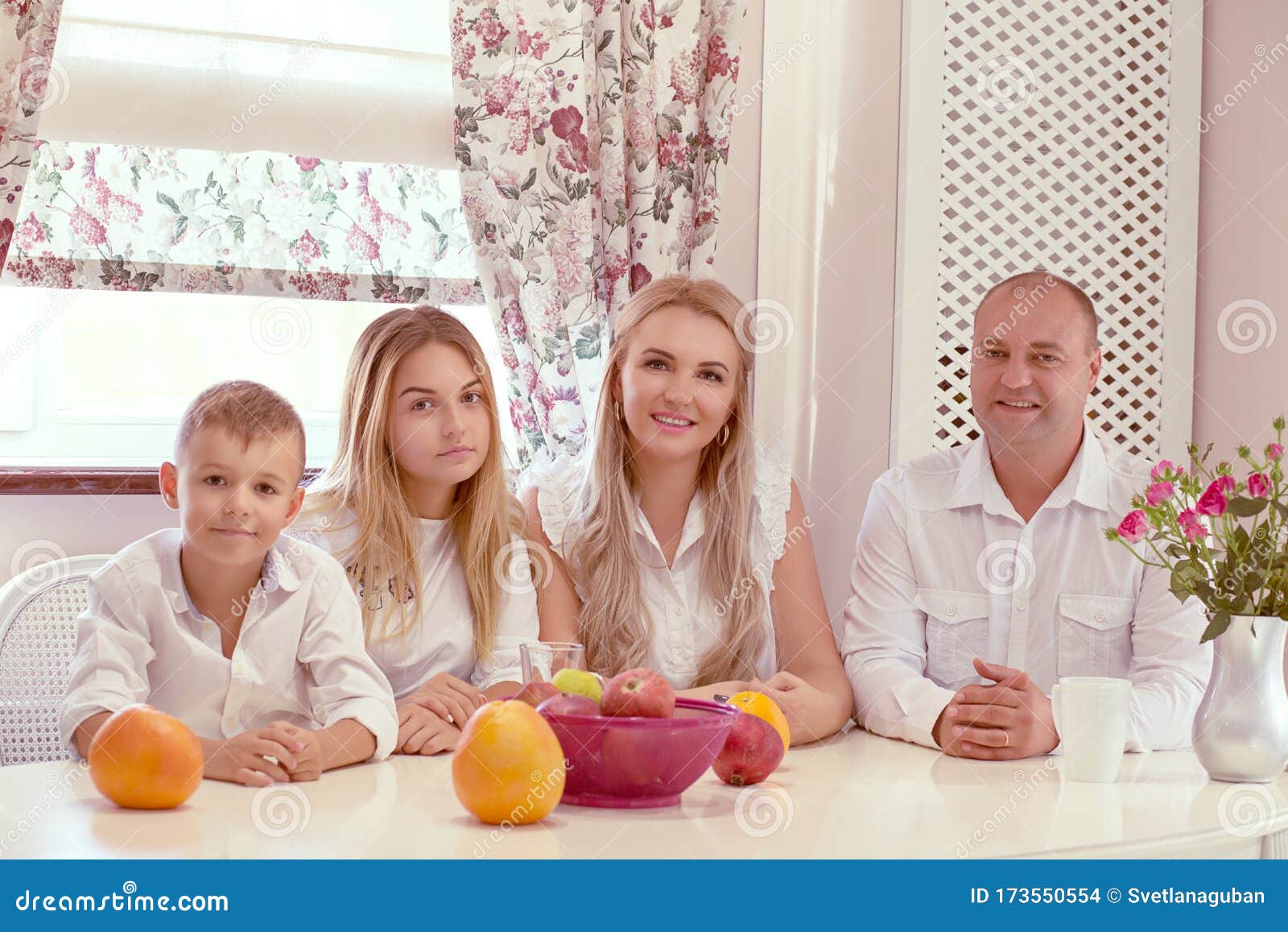 Happy family at the table stock photo. Image of blonde - 173550554