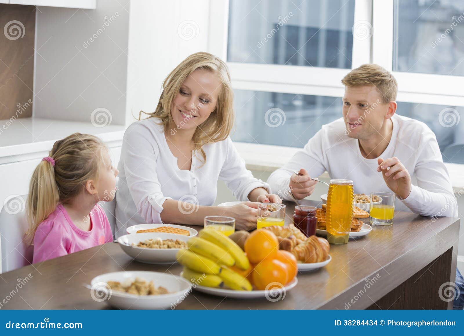 Happy Family of Three Having Breakfast at Table Stock Photo - Image of ...