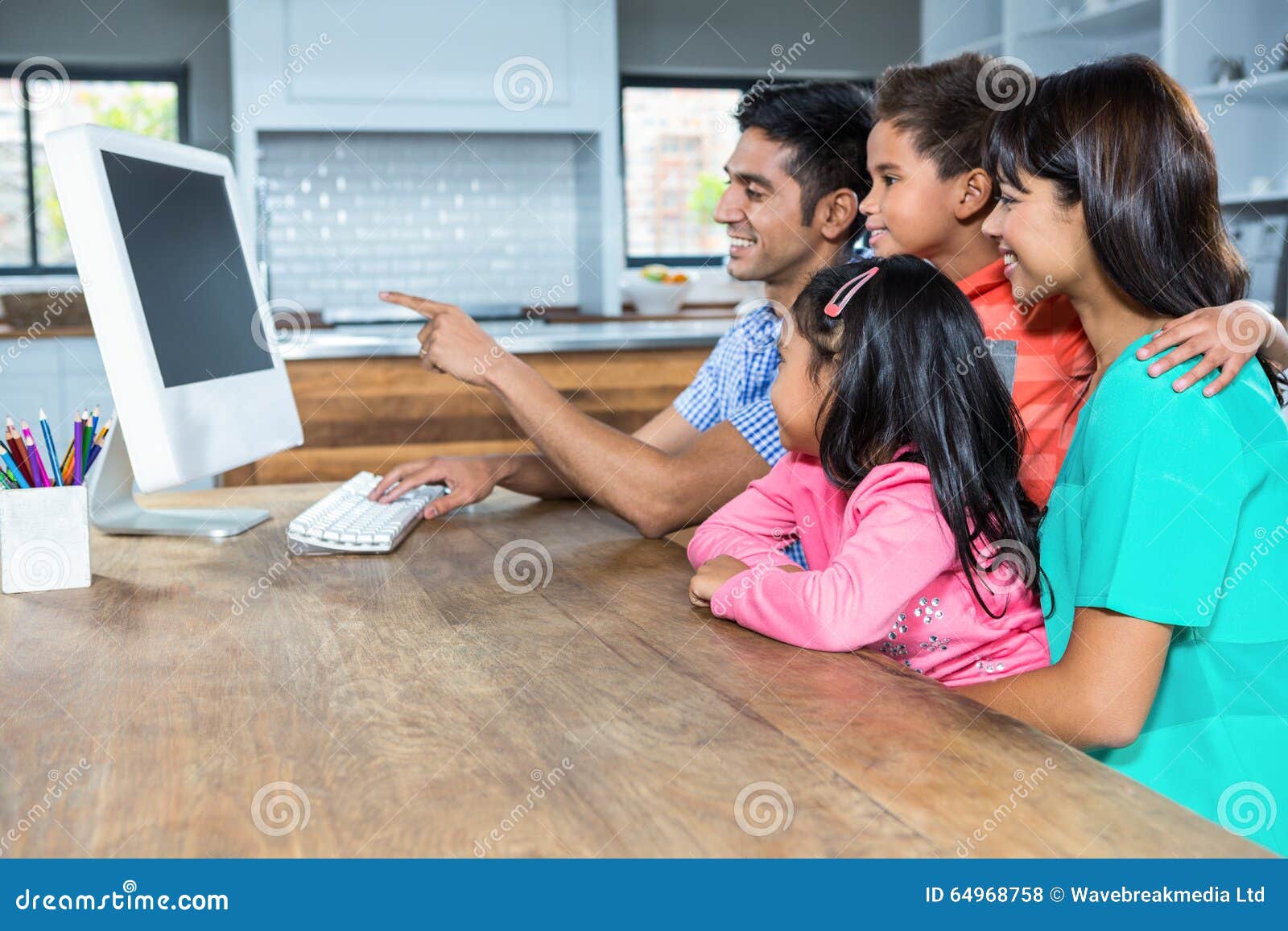 Happy Family Using Computer in the Kitchen Stock Photo - Image of ...