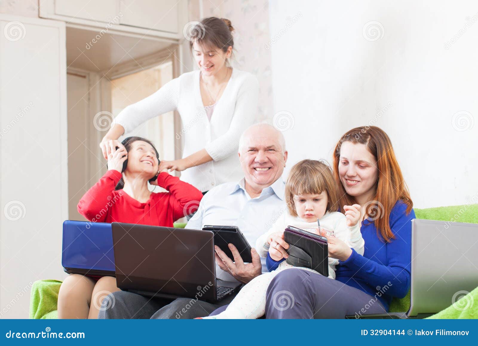 Happy Family Using Few Portable Computers Stock Photo - Image of mature ...