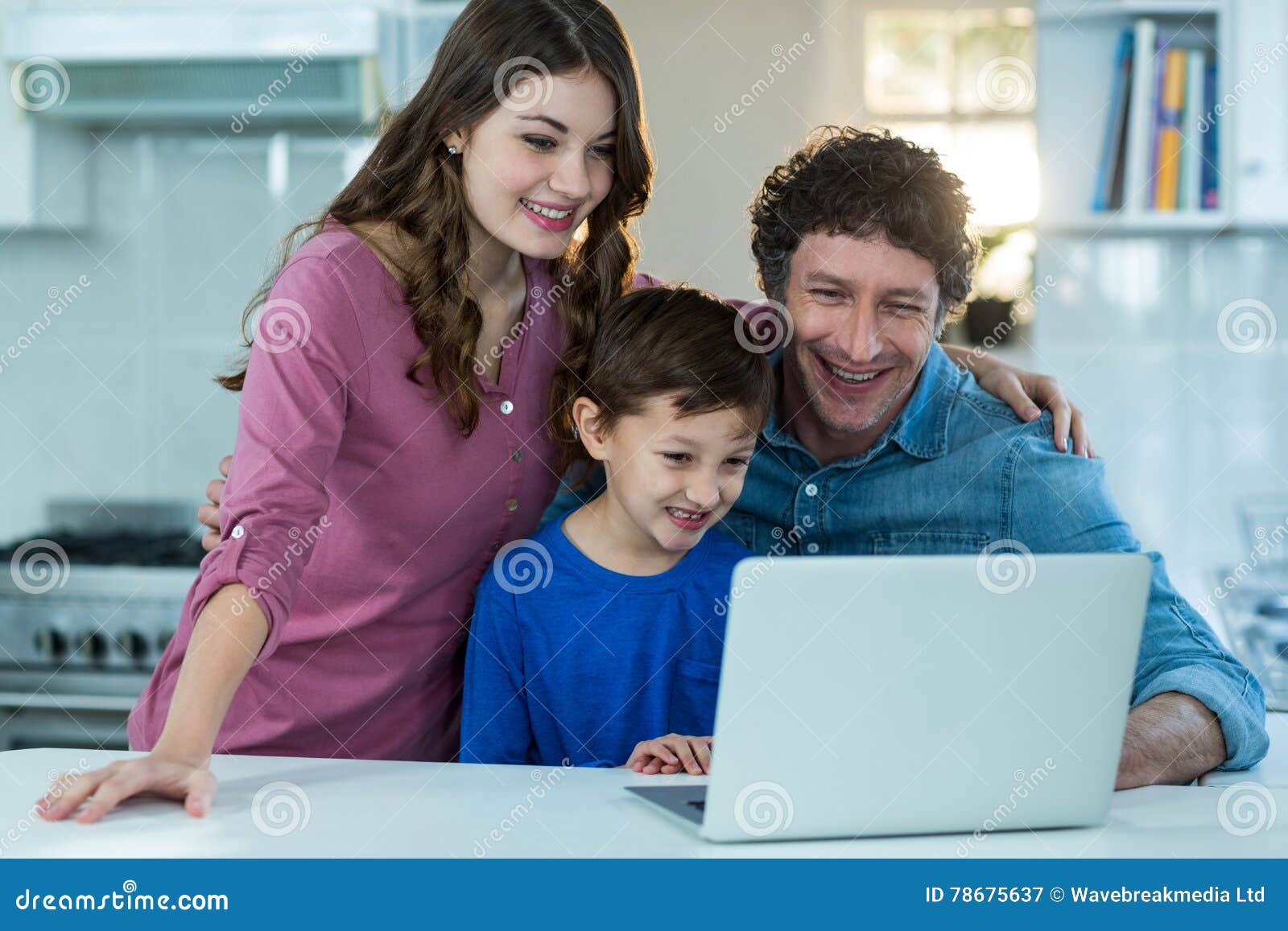 Happy family using laptop stock image. Image of casual - 78675637