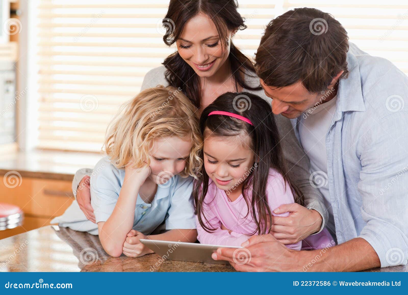Happy Family Using a Tablet Computer Together Stock Photo - Image of ...