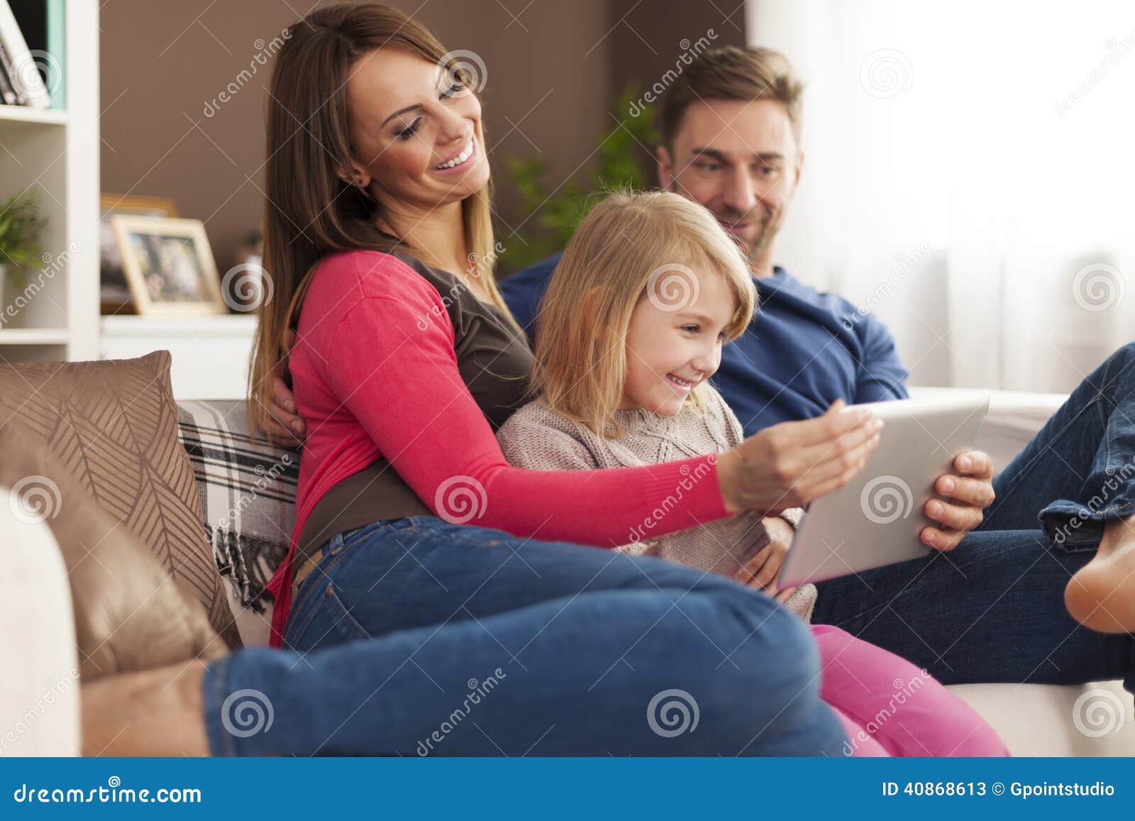 Happy family using tablet stock image. Image of interior - 40868613