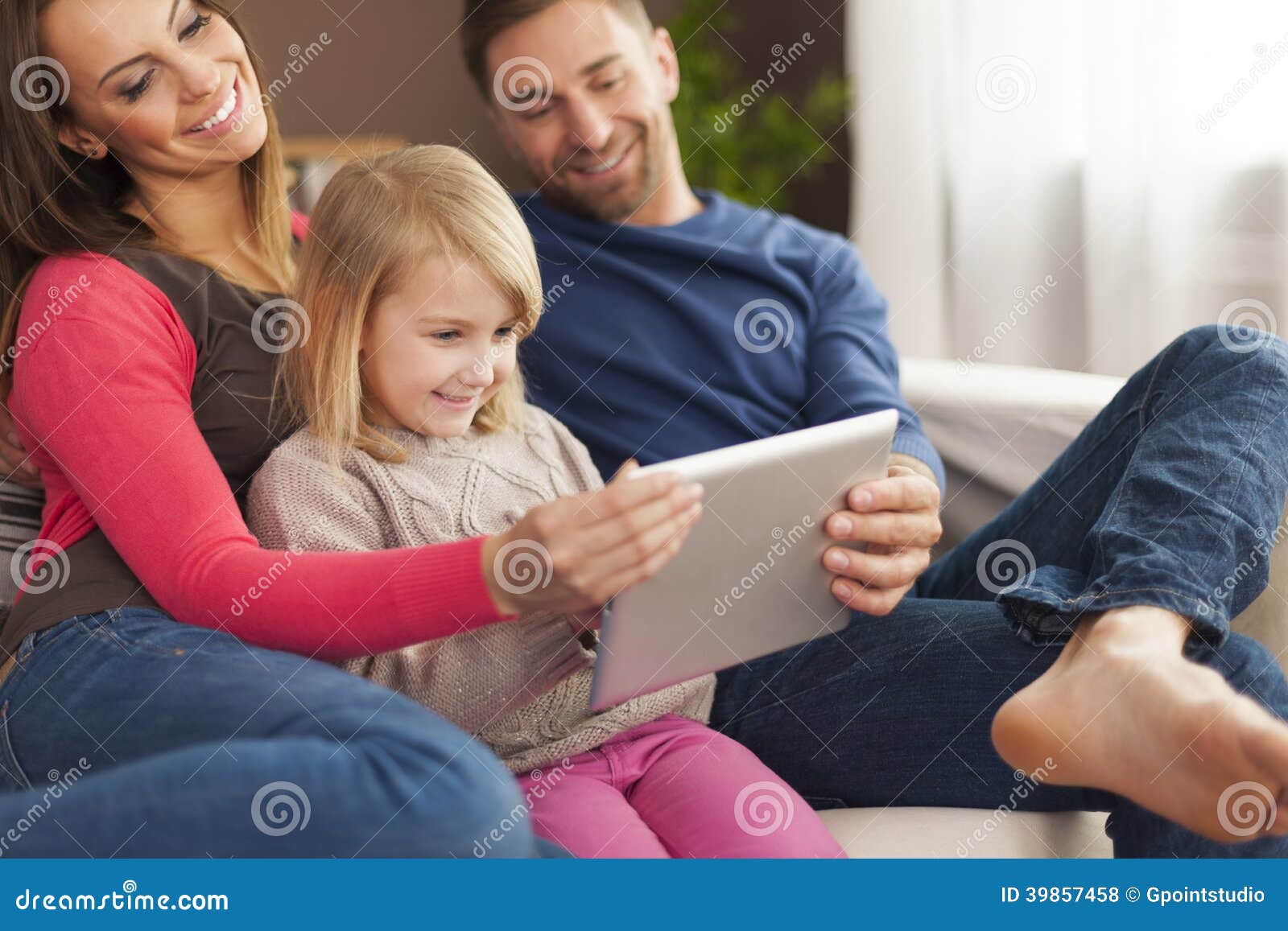 Happy family using tablet stock photo. Image of children - 39857458