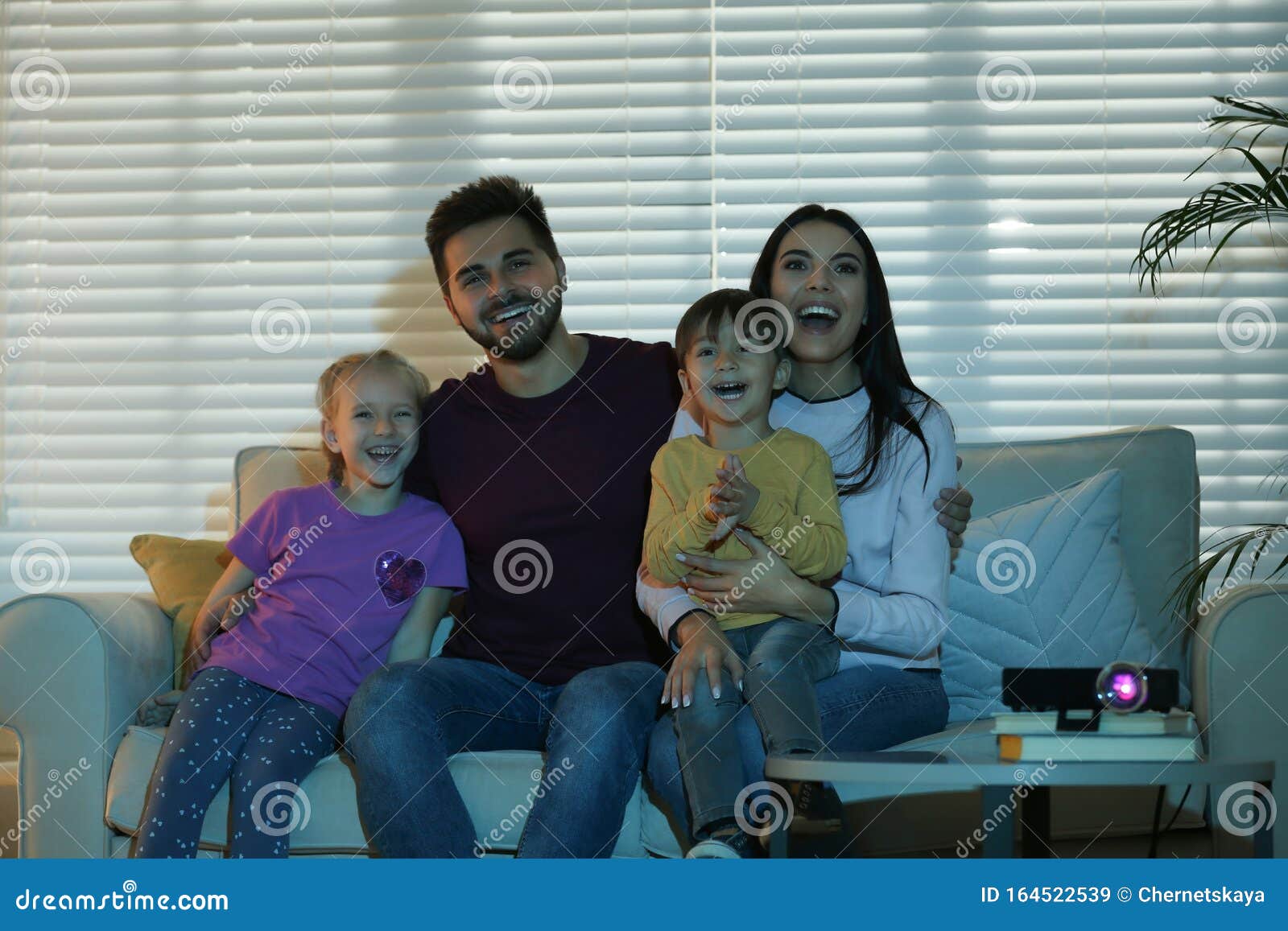Happy Family Watching Movie Using Video Projector Stock Image - Image ...