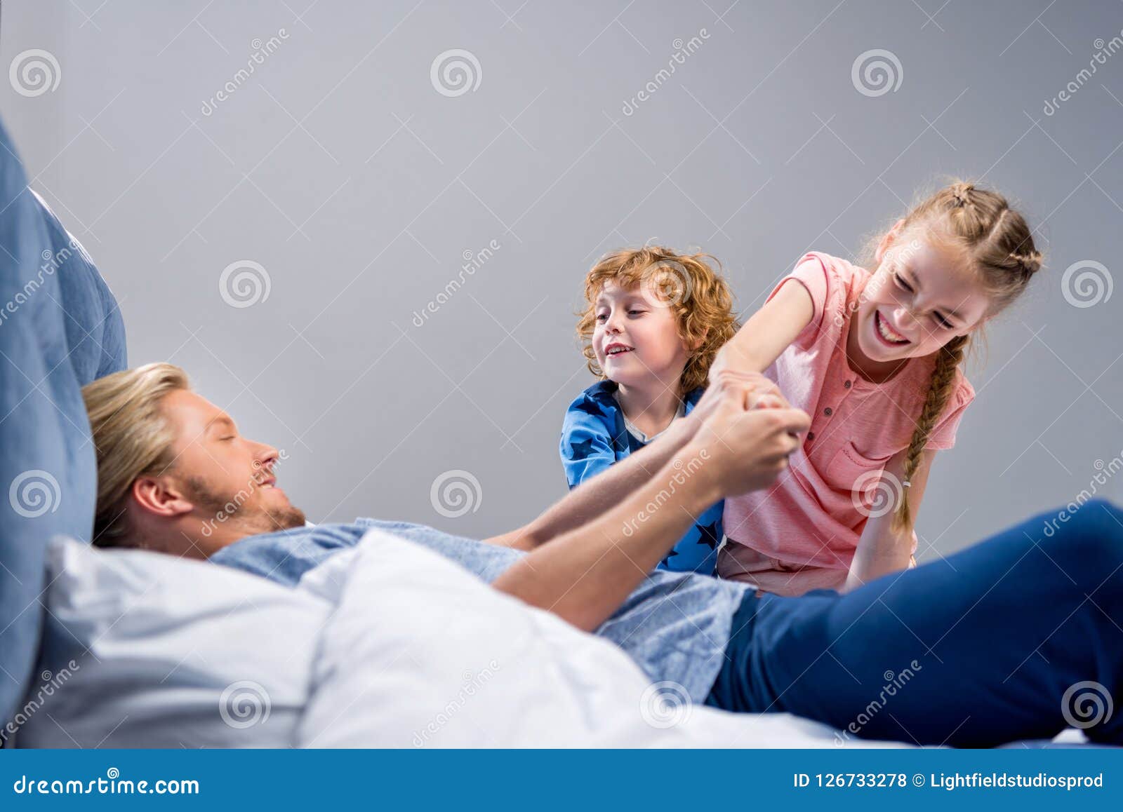 Happy Father with Cute Little Kids Having Fun Together in Bed Stock ... Happy Father with Cute Little Kids Having Fun Together in Bed Stock ...
