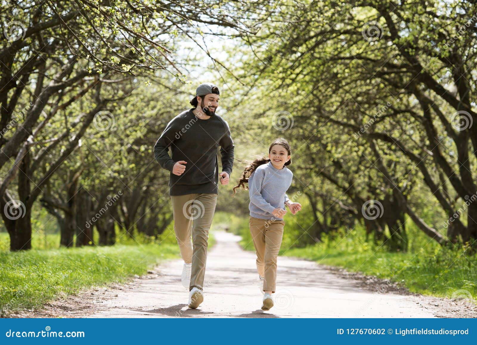 Happy Father and Daughter Running on Path Stock Photo - Image of park ...