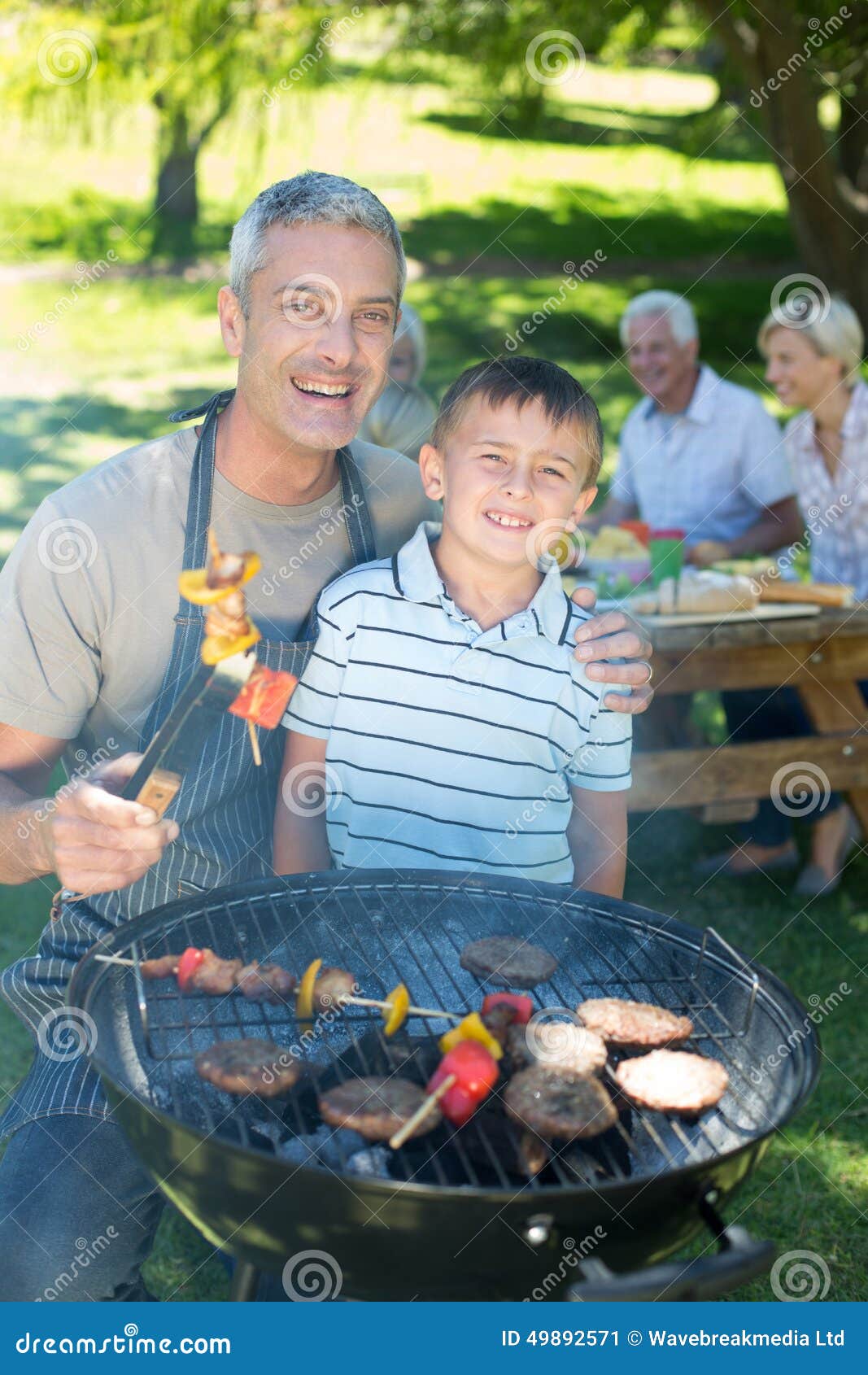 Happy Father Doing Barbecue with His Son Stock Image - Image of light ...