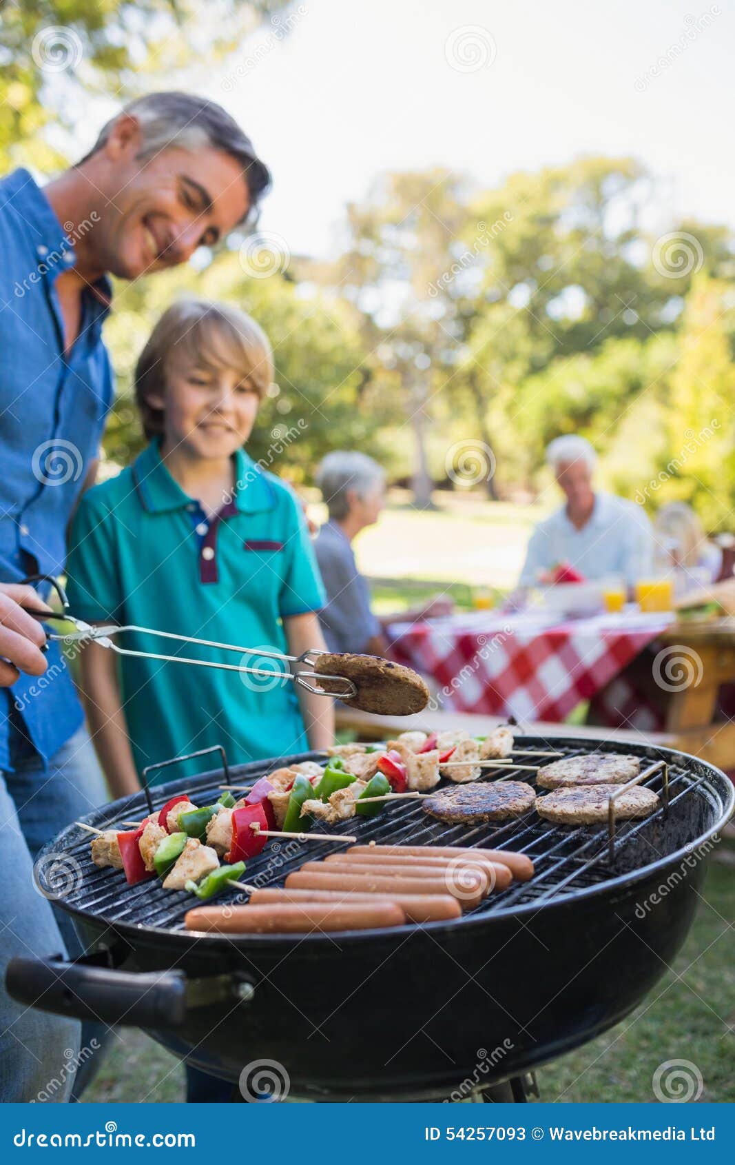 Happy Father Doing Barbecue with His Son Stock Image - Image of ...