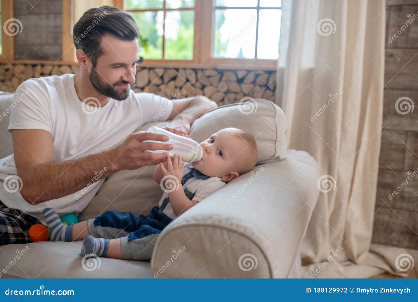 Father Feeding the Baby from the Bottle and Smiling Stock Photo - Image ...