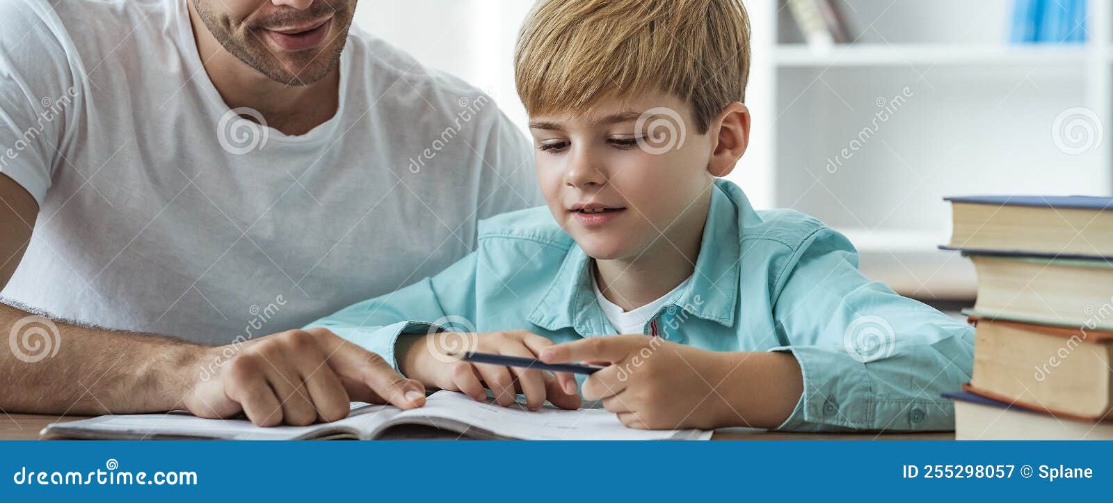 The Happy Father and a Son Doing Homework at the Desk. Stock Image ...