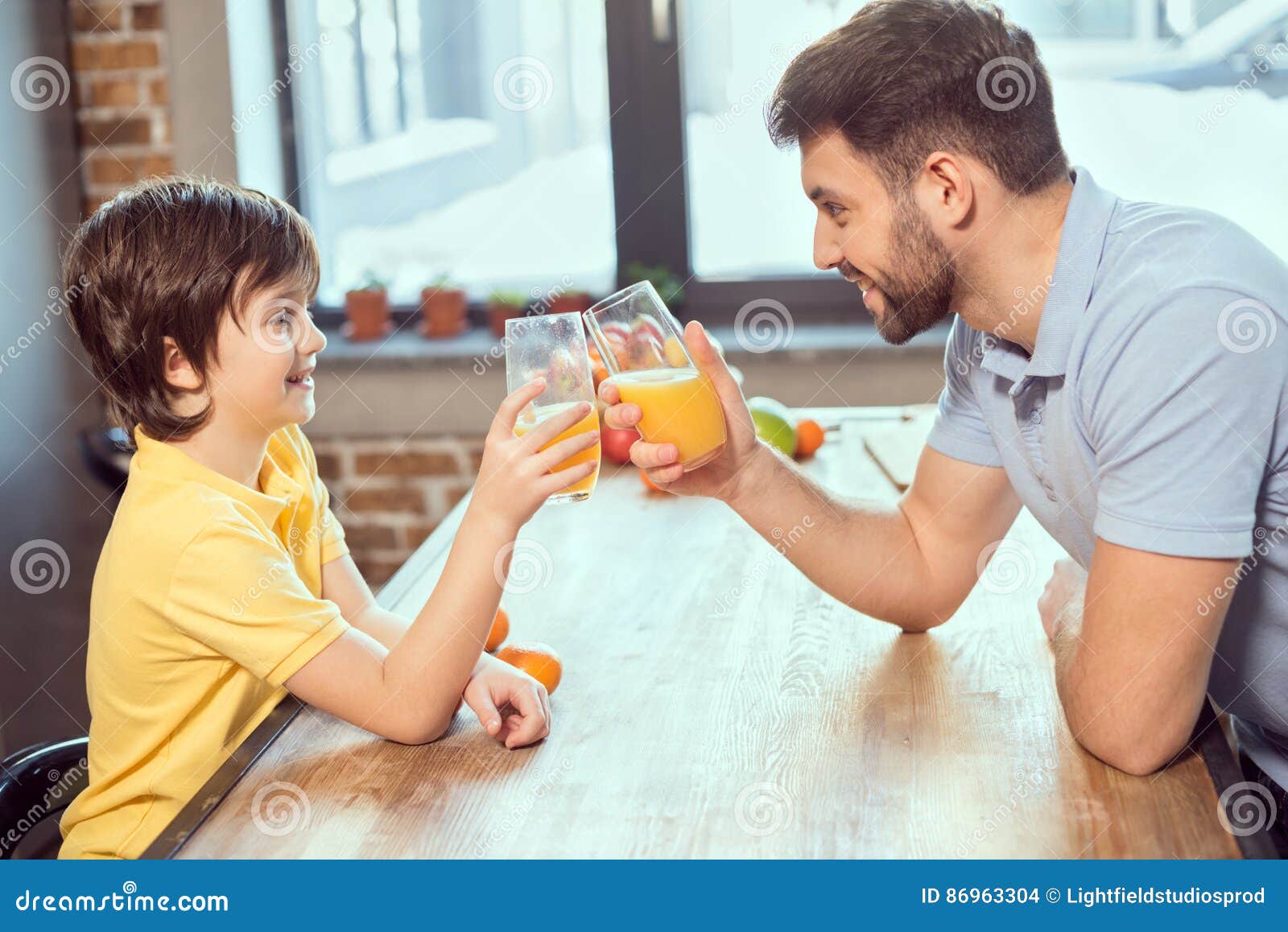 Happy Father and Son Drinking Fresh Juice Together Stock Photo - Image ...