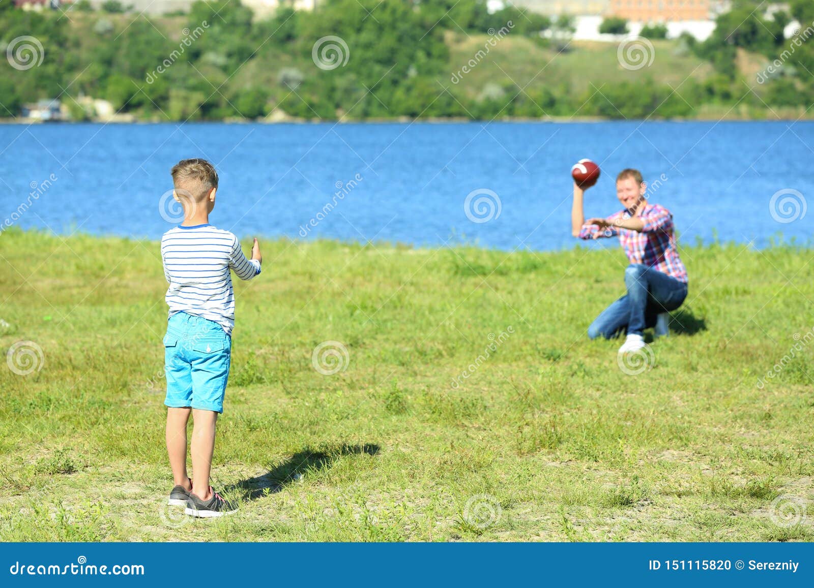Happy Father and Son Playing Rugby Near River Stock Photo - Image of ...