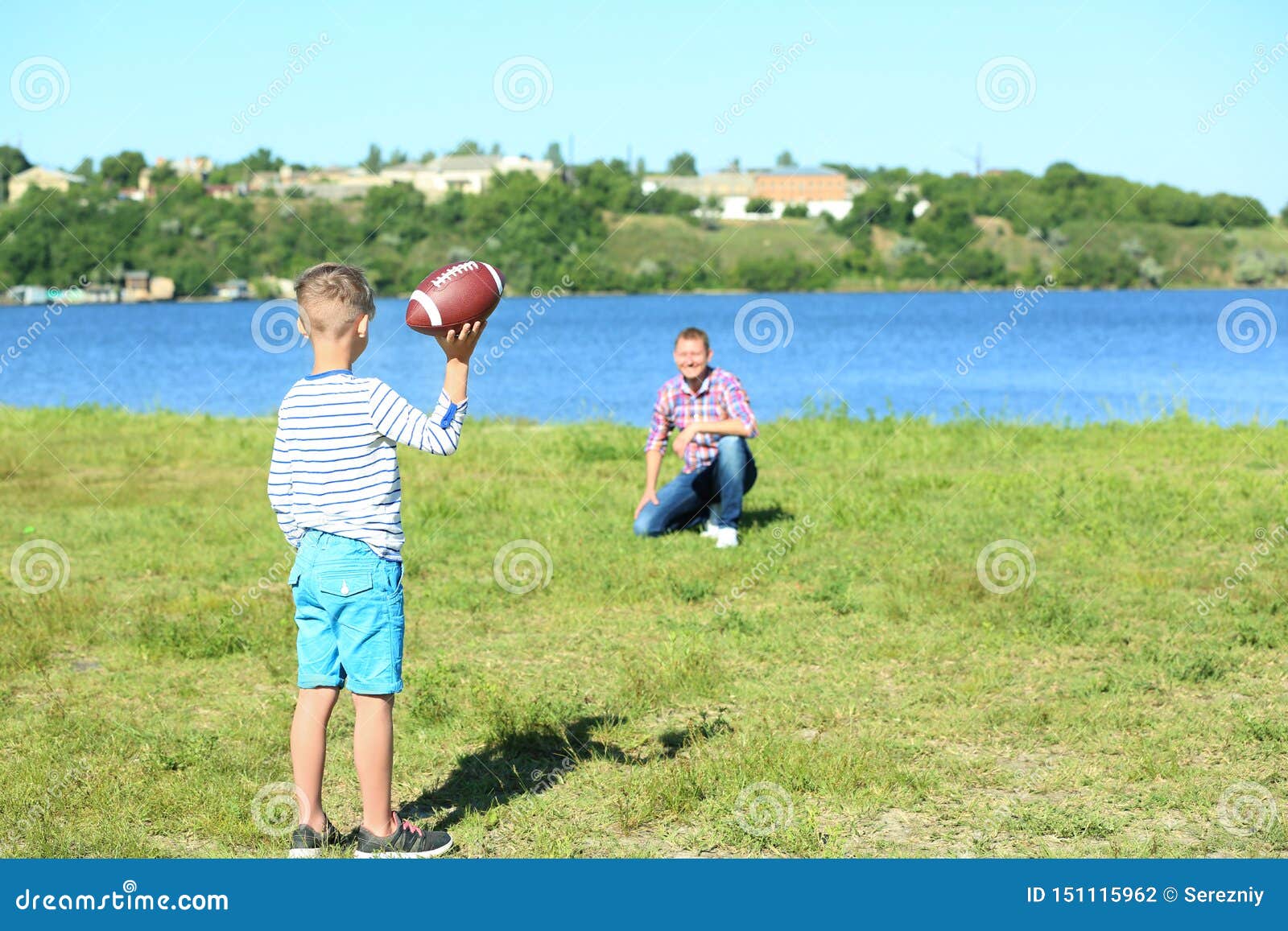 Happy Father and Son Playing Rugby Near River Stock Photo - Image of ...