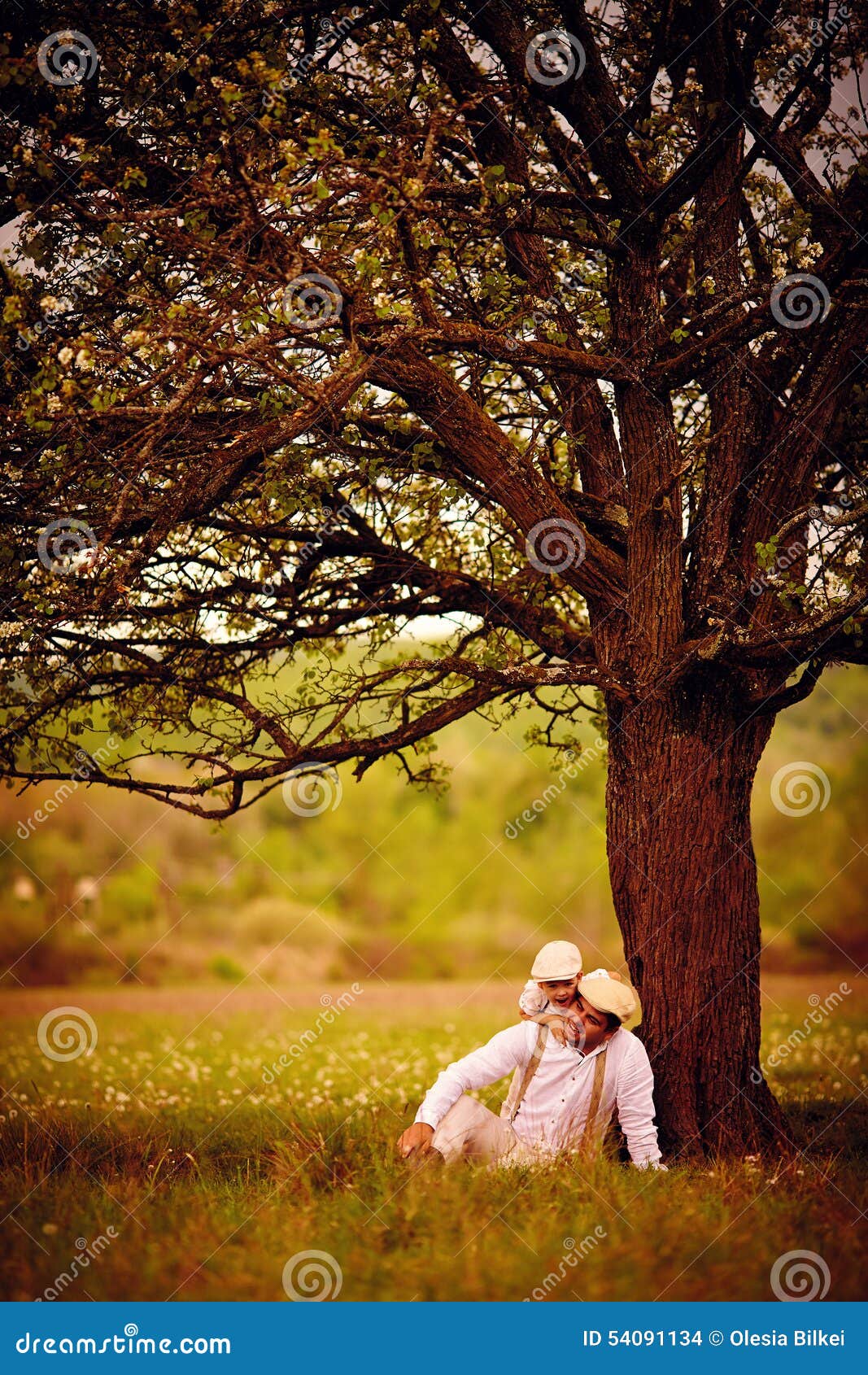Happy Father and Son Playing Together Under an Old Tree Stock Photo ...