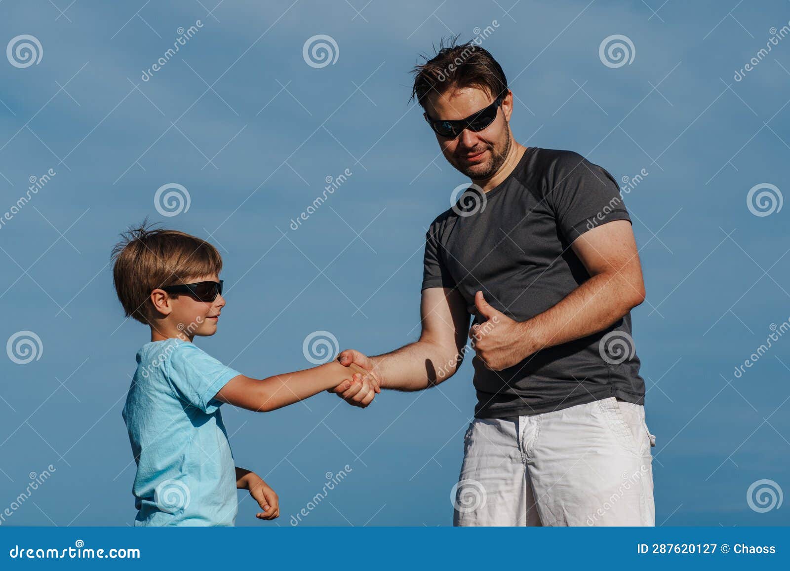 Happy Father and Son Shake Hands, Rejoicing in Their Success Stock ...