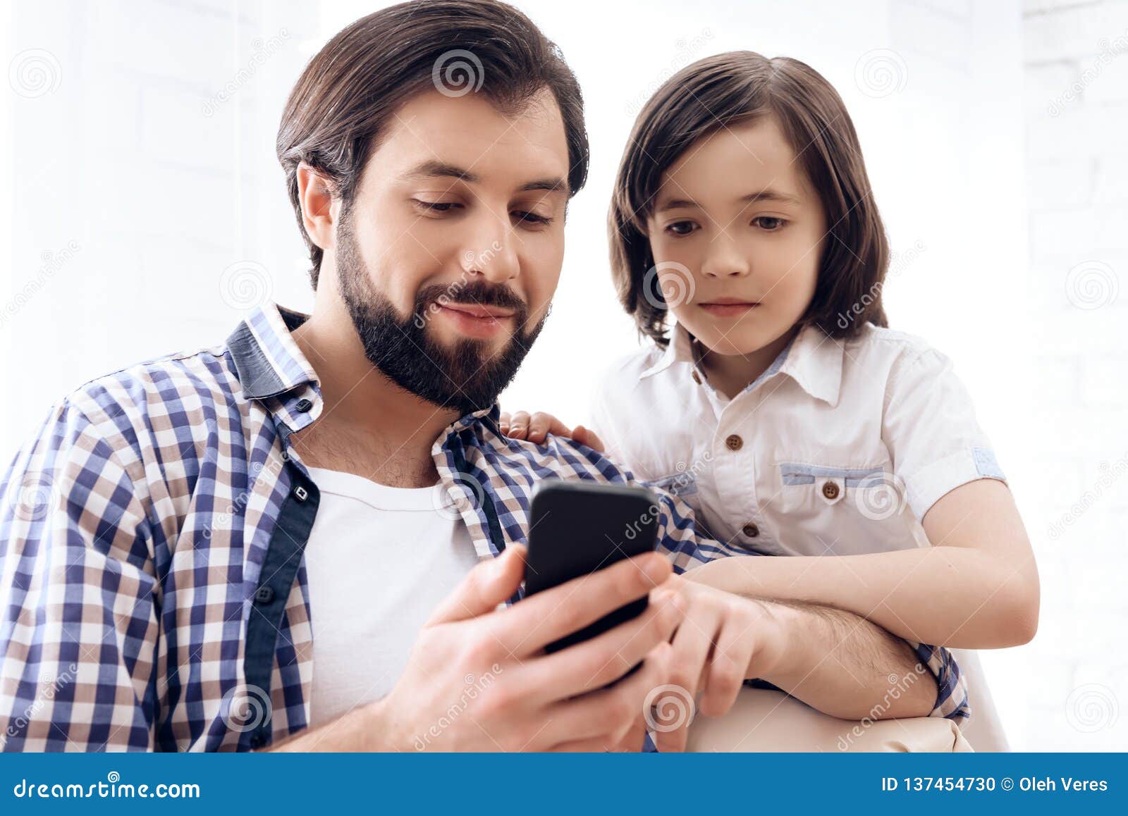 Happy Father and Son Use Smartphone at Domestic. Stock Photo - Image of ...