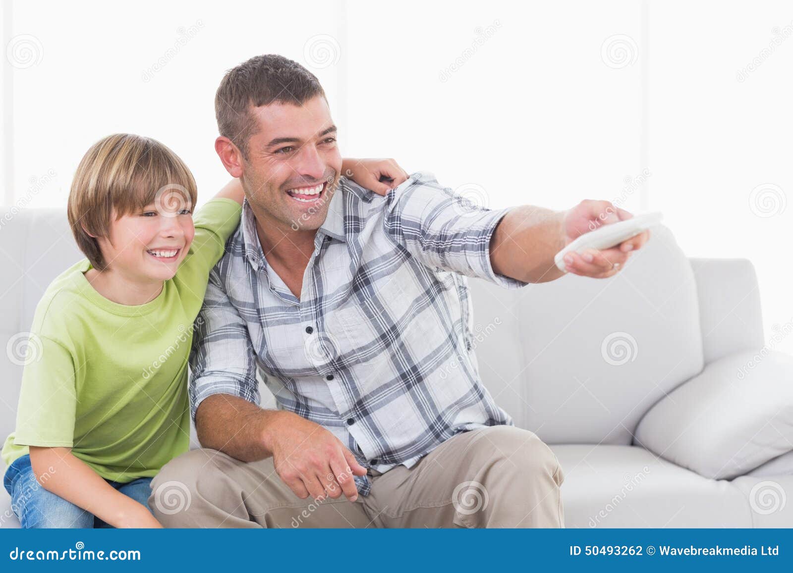 Happy Father and Son Using Remote Control Stock Photo - Image of button ...