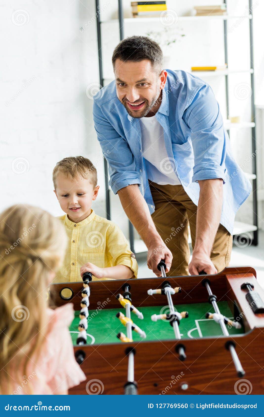 Happy Father with Two Adorable Kids Playing Table Football Stock Photo ... Happy Father with Two Adorable Kids Playing Table Football Stock Photo ...