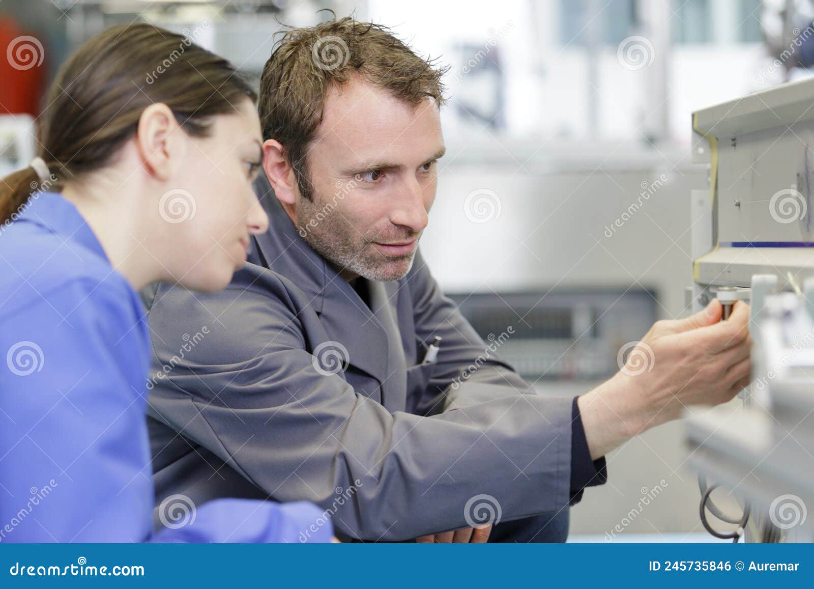 Happy Female Apprentice Engineer Working on Washing Machine Stock Photo ...