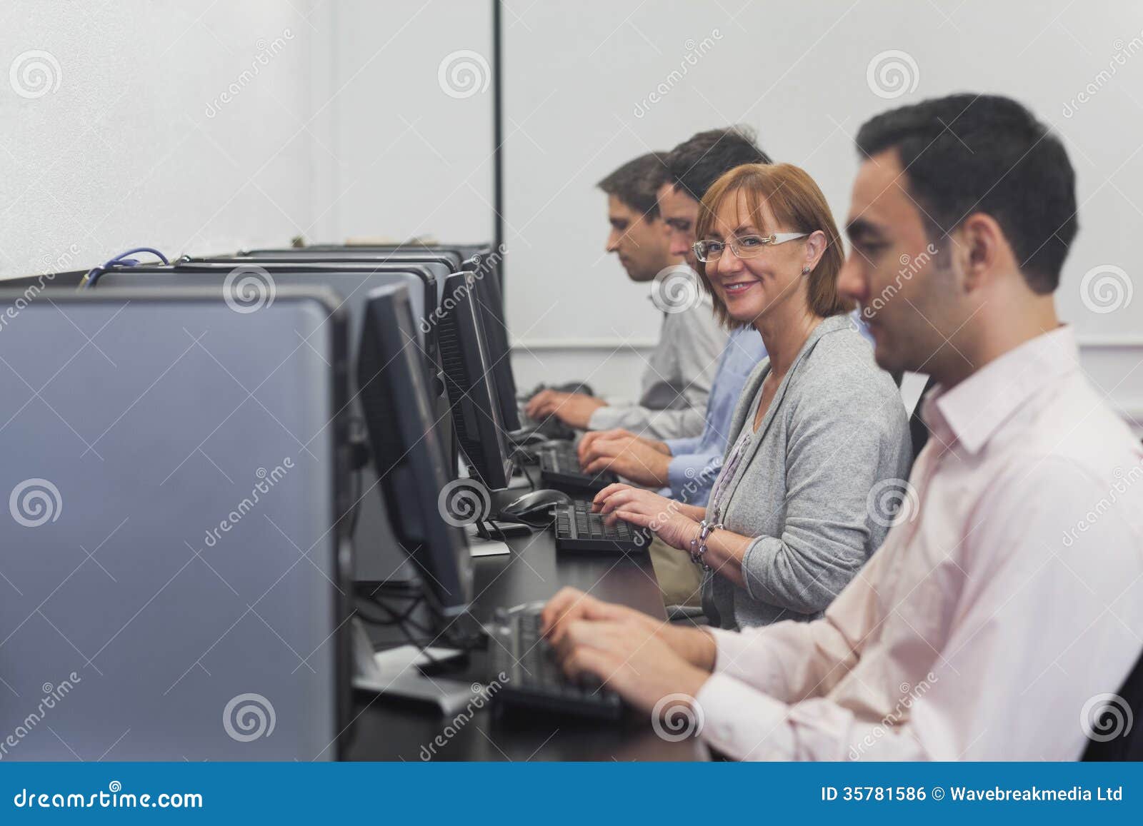 Happy Female Mature Student Sitting in Computer Class Stock Photo ...