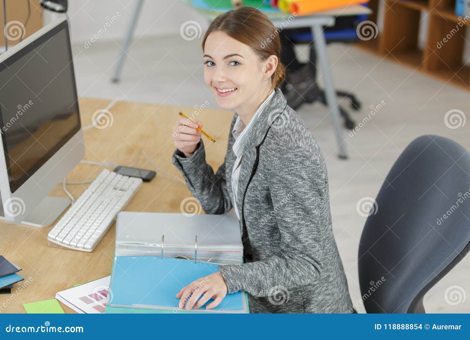 Happy female office worker stock photo. Image of book - 118888854