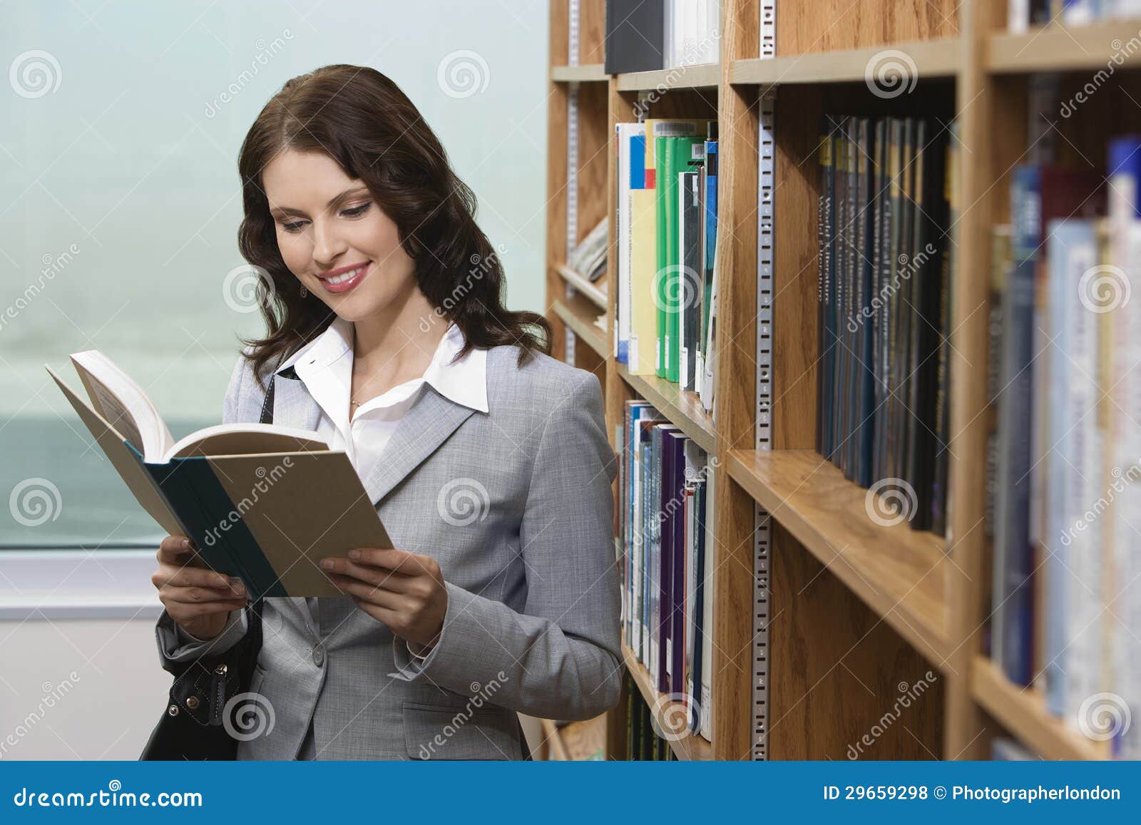 Happy Female Reading in Library Stock Photo - Image of profession ...
