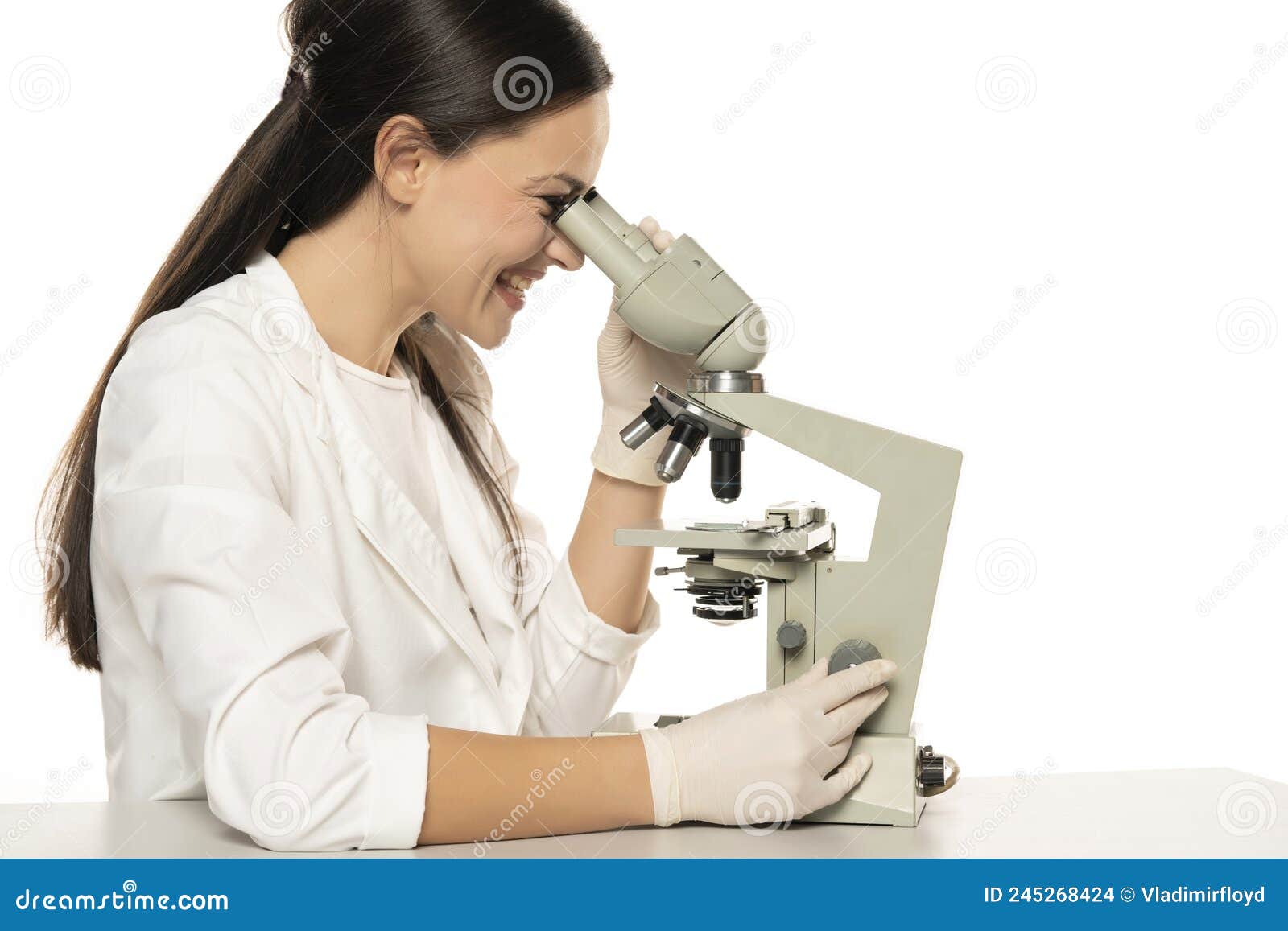 Happy Female Scientist Looking through a Microscope Stock Photo - Image ...