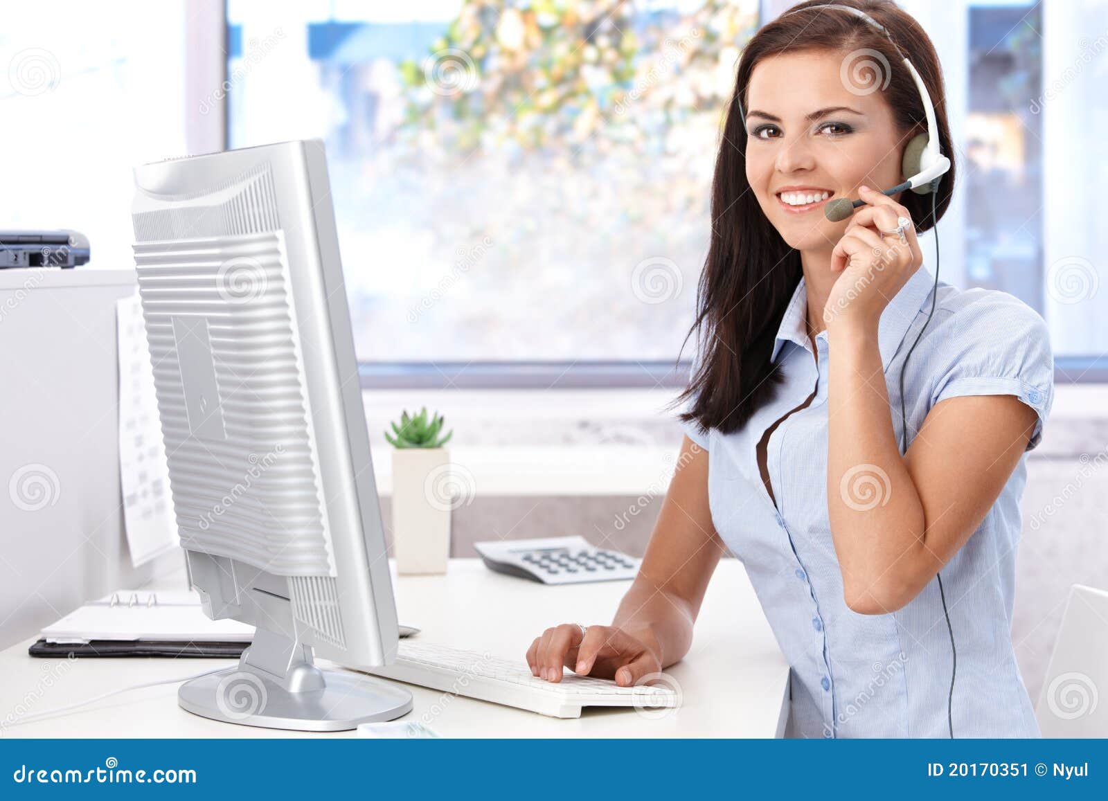 Happy Female Sitting at Desk in Bright Office Stock Image - Image of ...