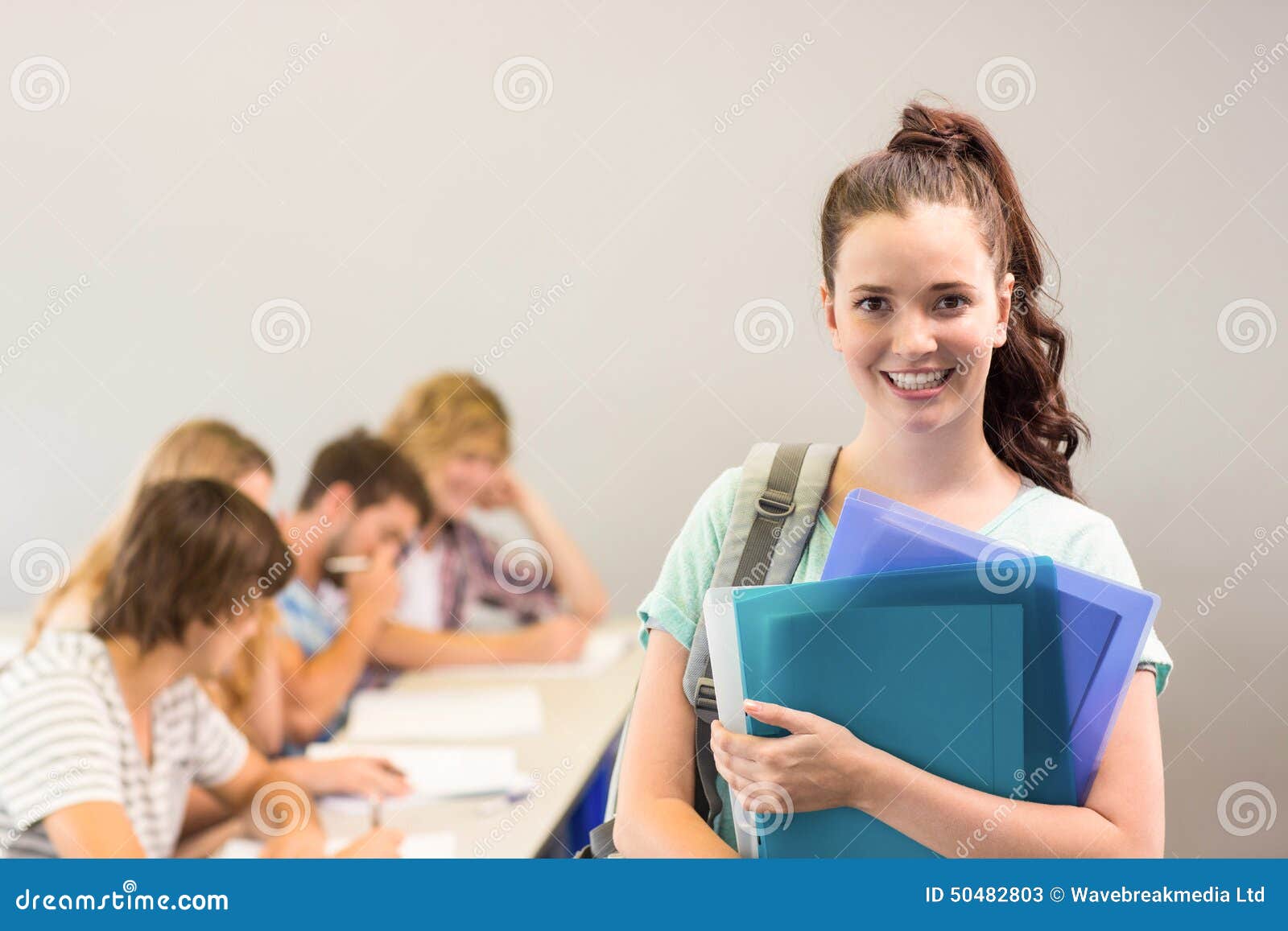 Happy Female Student Holding Folders Stock Image - Image of folder ...
