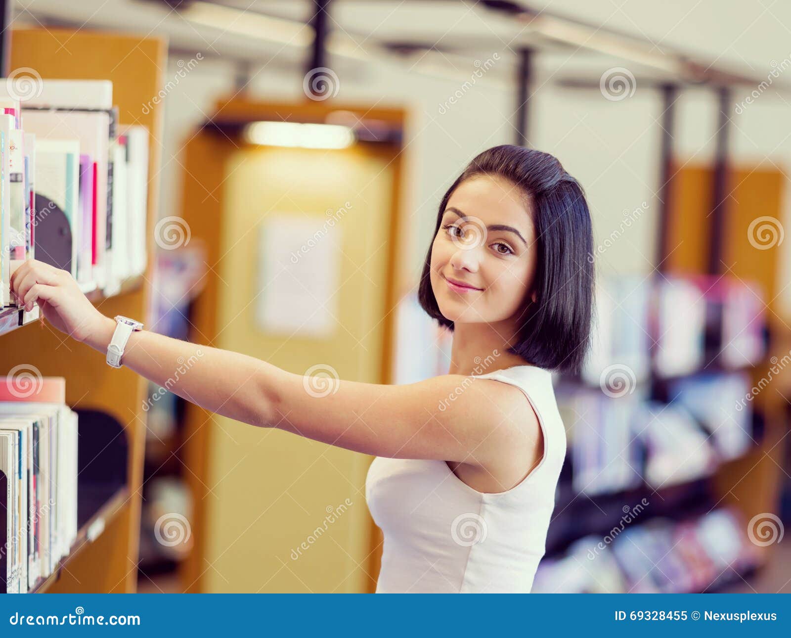 Happy Female Student at the Library Stock Image - Image of shelf ...