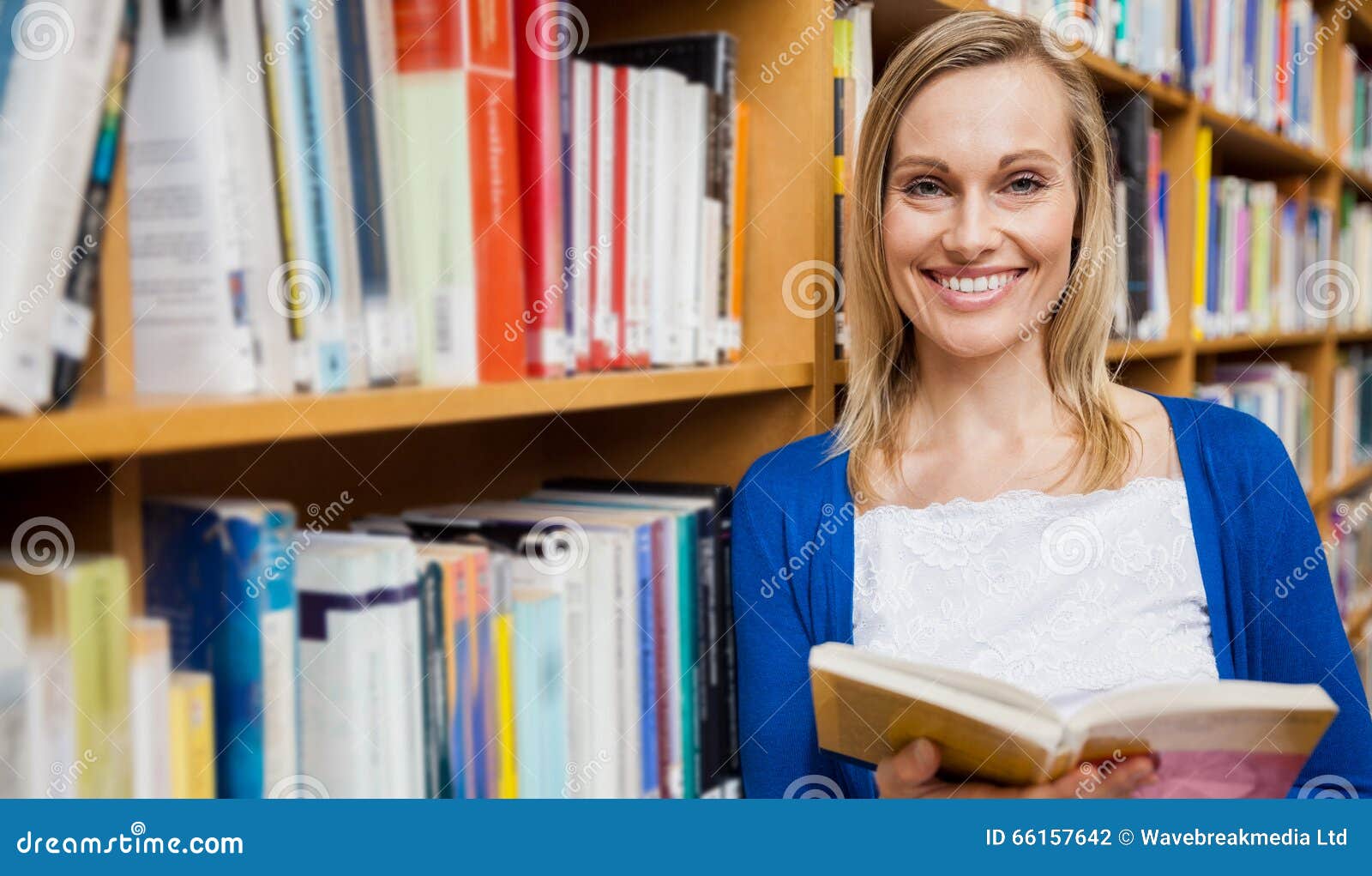 Happy Female Student Reading a Book in the Library Stock Photo - Image ...