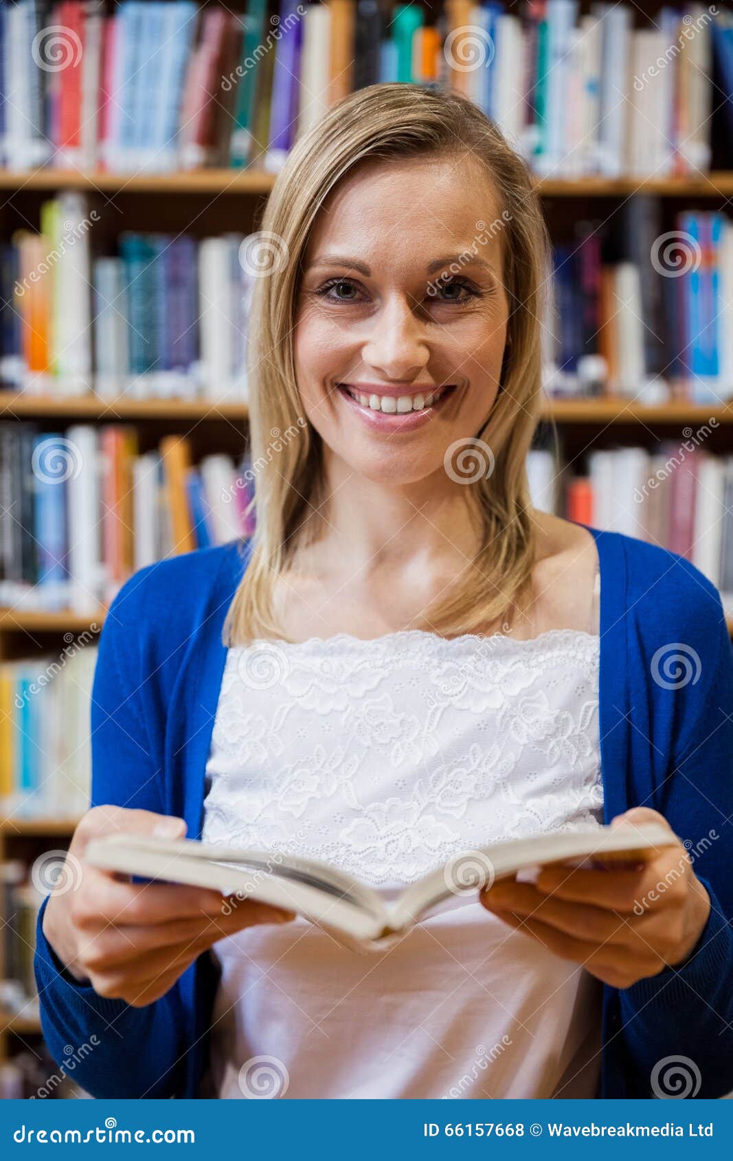Happy Female Student Reading a Book in the Library Stock Photo - Image ...
