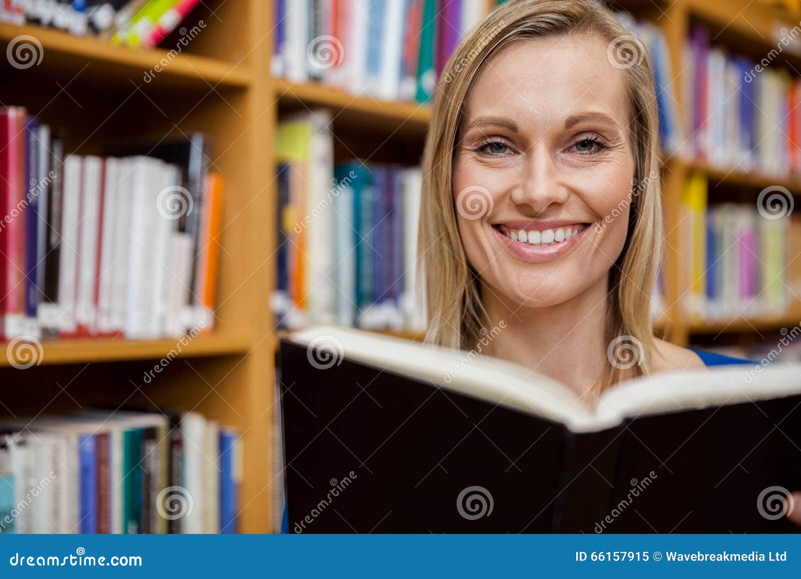 Happy Female Student Reading a Book in the Library Stock Image - Image ...