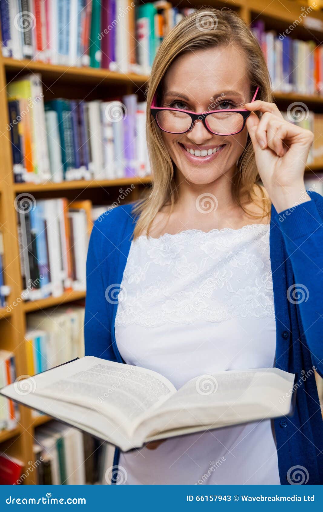 Happy Female Student Reading a Book in the Library Stock Image - Image ...