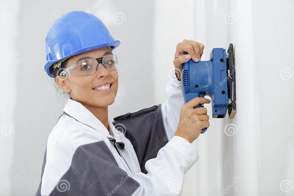 Happy Female Worker Sanding Wall Stock Photo - Image of improvement ...