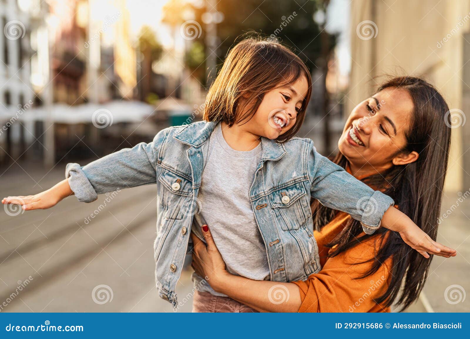 Happy Filipina Mother With Her Daughter Having Fun In The City Center