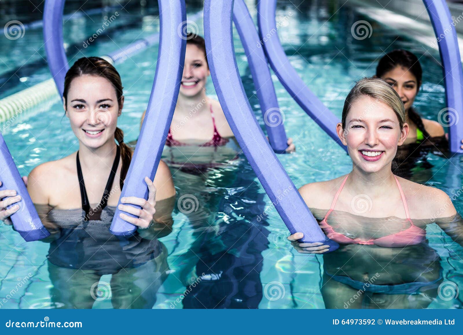 Happy Fitness Class Doing Aqua Aerobics with Foam Rollers Stock Photo ...