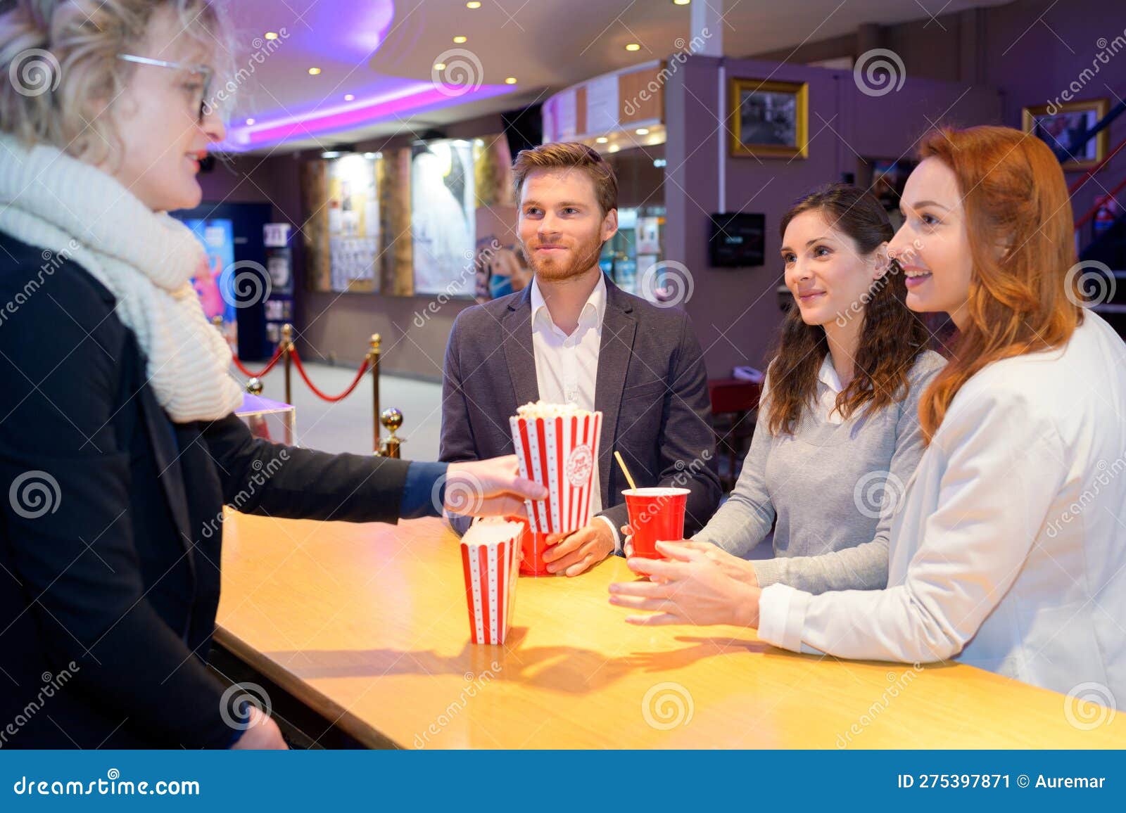 Happy friends at cinema stock image. Image of friends - 275397871