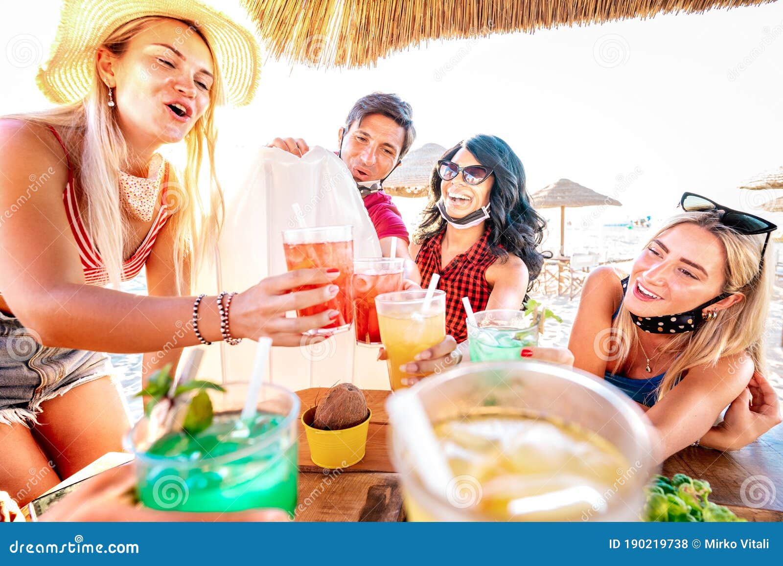 Happy Friends Drinking At Beach Cocktail Bar Wearing Face Masks New
