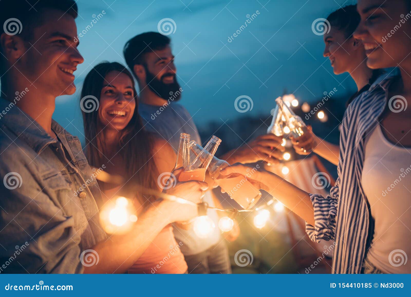 Happy Friends With Drinks Toasting At Rooftop Party At Night Stock